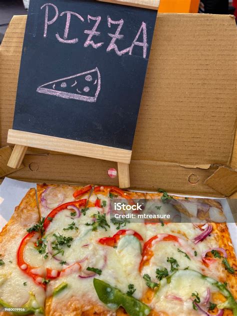 Closeup Image Of Sliced Rectangular Vegetarian Pizza In Cardboard