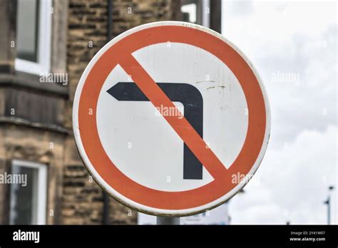 A Circular Traffic Sign With A Red Border And A Black Arrow Pointing Left Indicating No Left