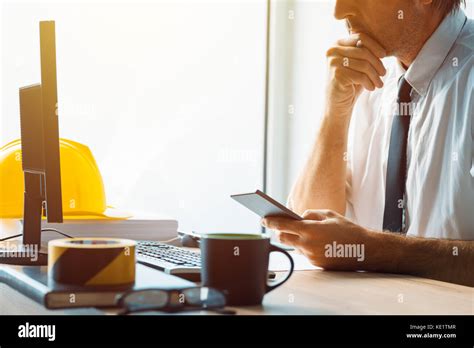Civil Engineer Using Smartphone In Architecture Office Adult Caucasian