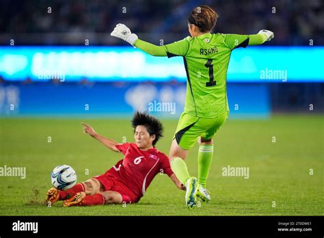 North Koreas Yujong Myong Takes A Shot Against Japans Goalkeeper Natsumi Asano During Their