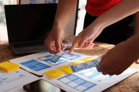 Premium Photo Group Of Ux Developer And Ui Designer Brainstorming About App Interface Design