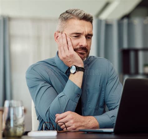Confused Bored And Business Man At Laptop In Office With Stress