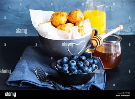 Homemade Honey Donuts On Ceramic Plate With Honey And Orange Juice As A