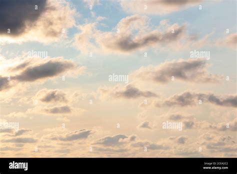 Sky Blue And Orange Light Of The Sun Through The Clouds In The Sky