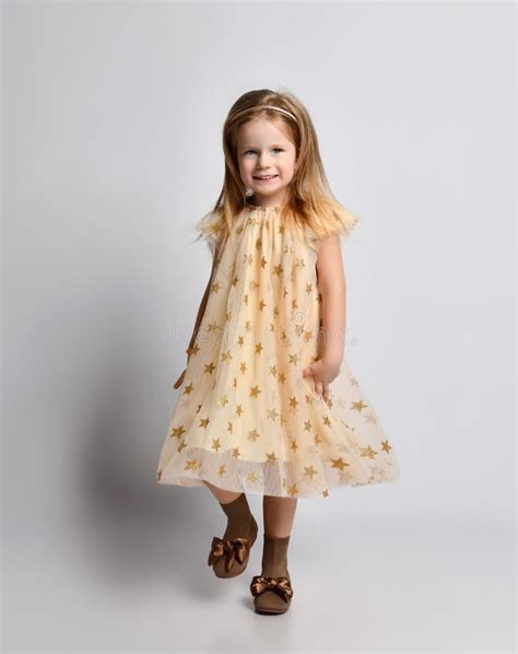 Two Small Beautiful Smiling Girls Sisters In Same Dresses With Stars