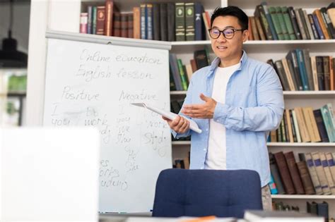 Premium Photo Chinese Teacher Having Online Lecture Standing Near
