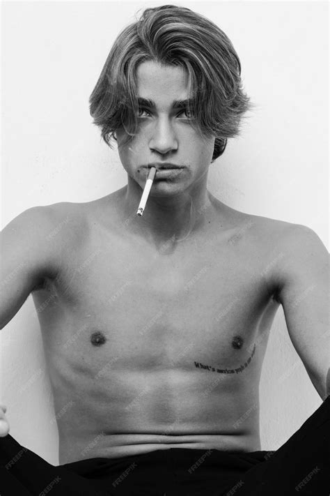 Premium Photo Portrait Of Shirtless Man Smoking Against White Background