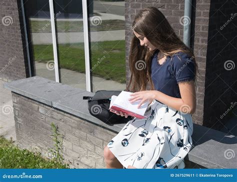 Student Girl Teenager Reads Notes Before The Lesson Of Recess Stock