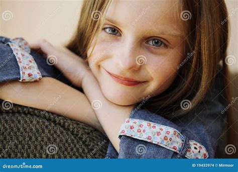 Small And Happy Angel Smiling And Sitting On A Chair Royalty Free
