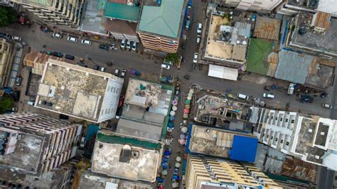 An Overhead View Of A Street With Lots Of Buildings And Vehicles Stock