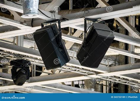 Powerful Loudspeakers Suspended From Supporting Structures Under The Ceiling Of A Large Arena
