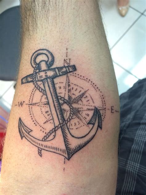 An Anchor And Compass Tattoo On The Arm