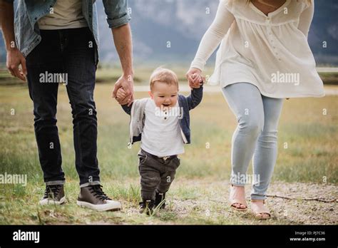Parents Walking With Baby Son In Field Stock Photo Alamy