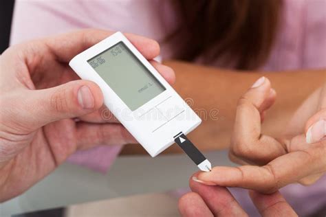 Doctor Using Glucometer On Patient S Finger Stock Image Image Of