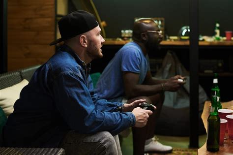 premium photo tense man in casualwear pressing buttons on joystick