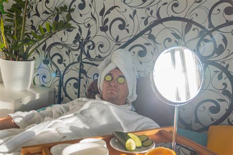 A Man And Home Spa Care At Home Takes Care Of Himself And Smears His Face With Cream Does A ...