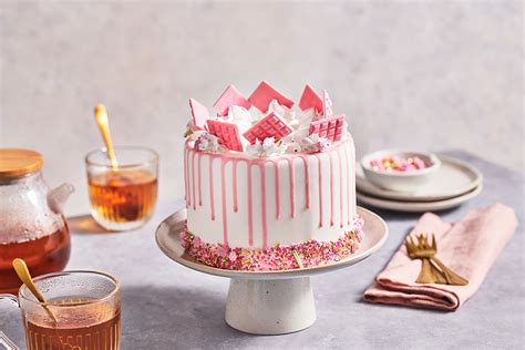 Light Pink Drip Cake With Sprinkles And Mini Choco Bars Funcakes