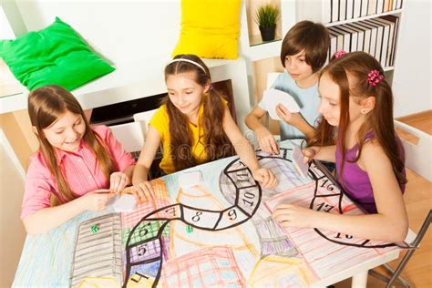 Un Punto Di Vista Superiore Di Quattro Bambini Che Giocano Il Gioco Da Tavolo Fotografia Stock