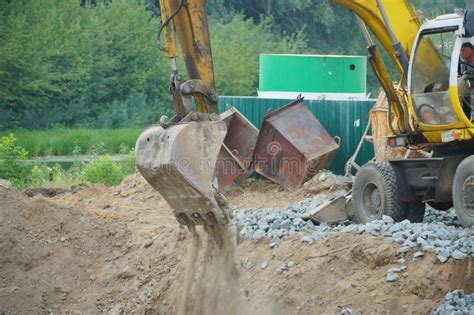 An Excavator And Other Heavy Construction Equipment Are Working On The