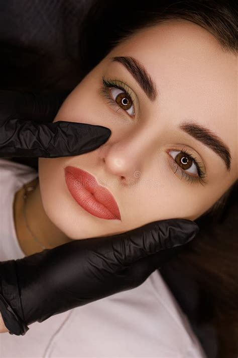 Lips Of A Female Model Close Up After The Procedure Of Permanent Lip