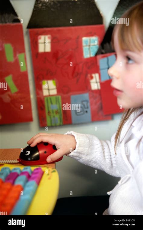 Primary School Pupil Holding Mouse And Working On Computer Stock Photo Alamy