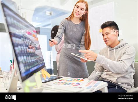 Programmers And Women As Web Developers On The PC Are Working On A Design Project Stock Photo