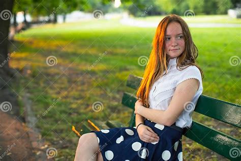 Young Long Haired Girl Sitting In A Park During Golden Sunset Stock Image Image Of Long