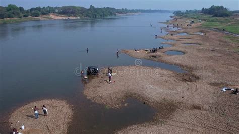 Aerial View Of People Bathing On The Side Of A Large River Stock Footage Video Of Procession
