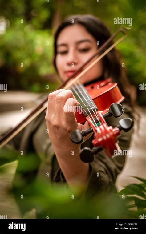 Lifestyle Of Girl With Her Violin Playing A Melody Outdoors Concept Of