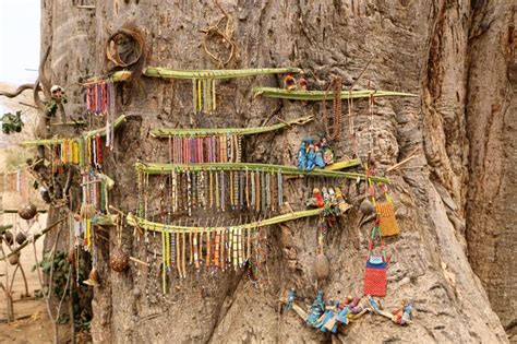 Array Of Colorful Artisanal Crafts Hang From The Branches Of A Tree Suspended From Rope Stock