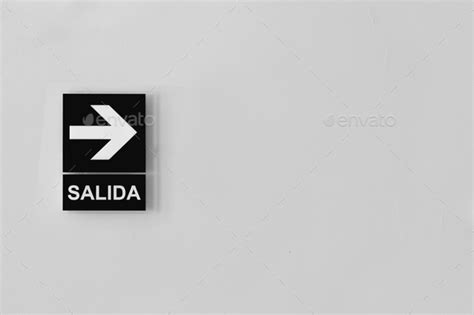 Grayscale Shot Of An Exit SALIDA Sign In Spanish With Right Arrow Stock Photo By Wirestock