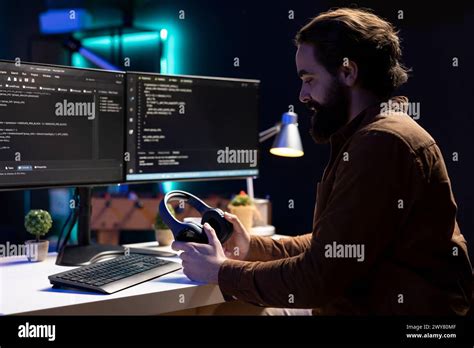 programmer putting headphones on while implementing security measures