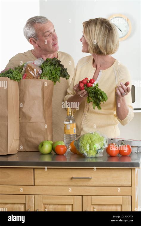 Couple Unloading Groceries Stock Photo Alamy