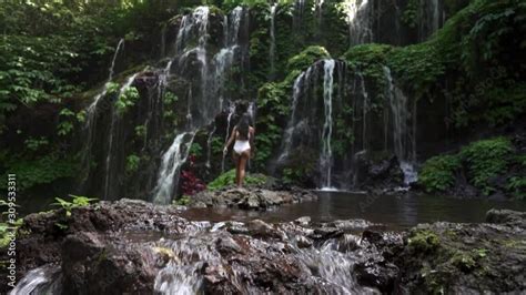 Vidéo Stock Woman enjoying near hidden in jungle cascade waterfall in