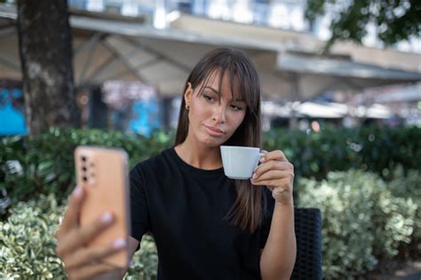 일상 생활 카페에서 아침 검은 술잔에 매력적인 여성 커피 및 소셜 네트워크를위한 셀카 사진 만들기 가리키기에 대한 스톡 사진 및 기타 이미지 Istock