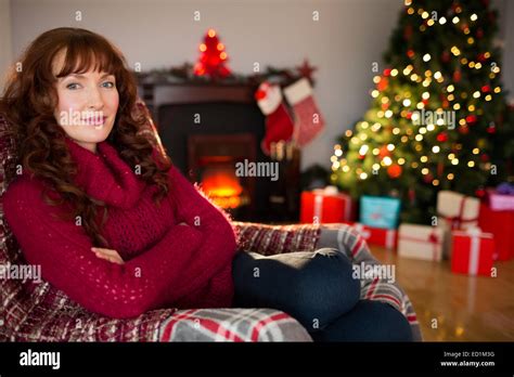 Pretty Redhead In Jumper Sitting On The Armchair At Christmas Stock Photo Alamy