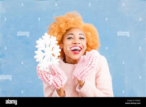 Portrait Of A Woman With Artificial Snowflake On The Blue Background
