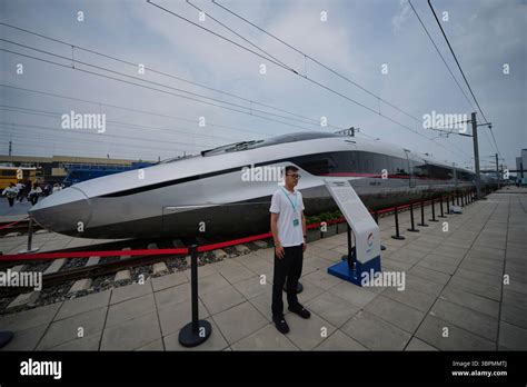 A Volunteer Stands Next To The New Generation Of Fuxing Cr450 High Speed Emu As Delegates To The