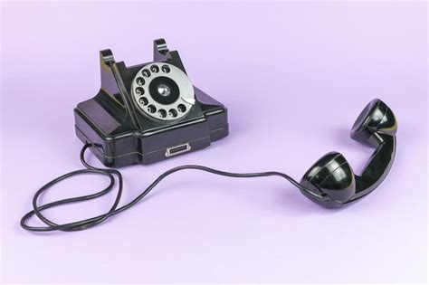 Premium Photo A Retro Black Handset With The Handset Off On A Purple