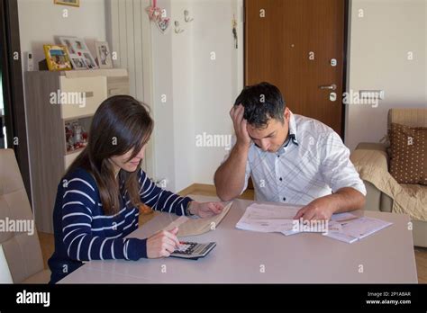 Image Of A Couple Making Calculations And Checking Bills And Expense