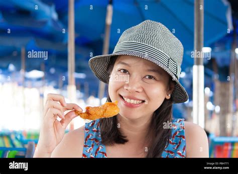 Woman Eating Seafood Outside In Summer Smiling Happy At Camera Asian