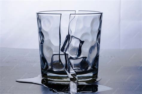 Premium Photo Broken Glass Glass In Two Halves With An Ice Cube