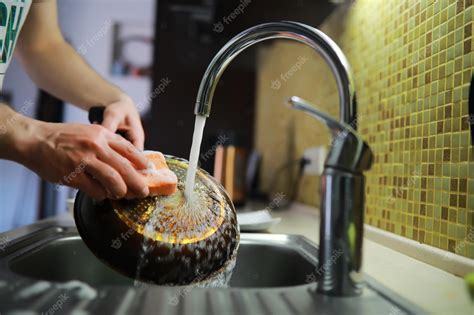 Premium Photo Man Washing Dish In Sink At Restaurantpeople Are