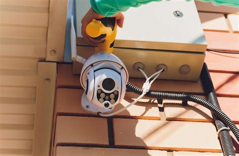 Premium Photo Technician Female Setup Cctv Camera On Wall