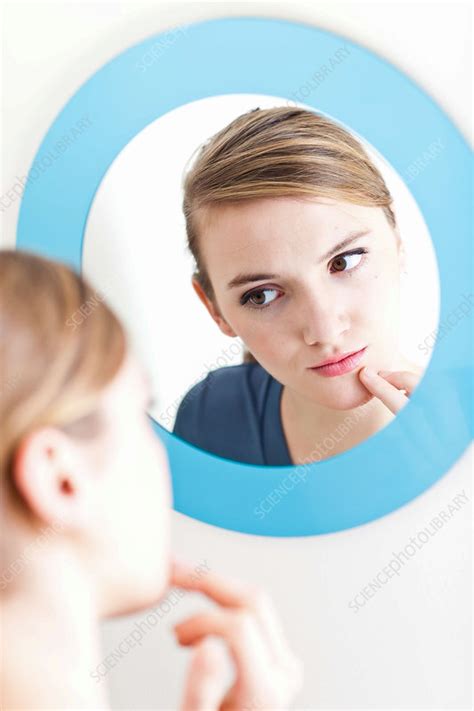 Woman Checking Her Face In The Mirror Stock Image C033 1398
