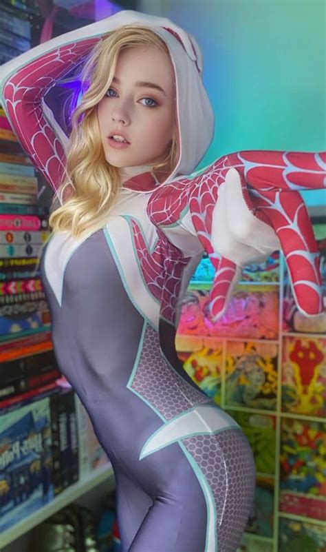 A Woman In A Spider Suit Posing For The Camera With Her Hands On Her Hips