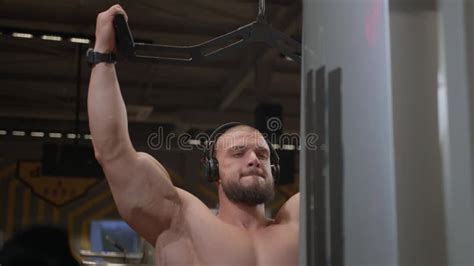 Strong Muscular Shirtless Man Doing Vertical Chest Row While Sitting