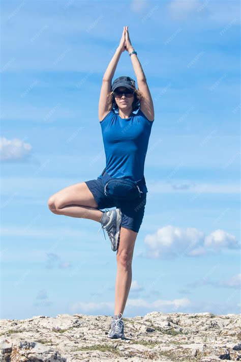 Premium Photo The Girl Is Engaged In Yoga On A Background Of Cloudy