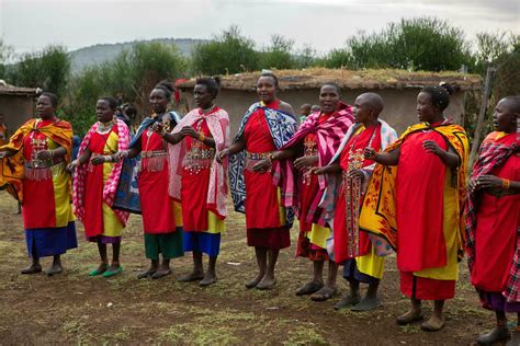 Masai In Traditional Colorful Clothing Showing Maasai Jumping Dance At