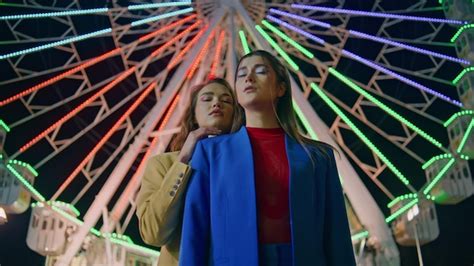 Premium Photo Models Posing Amusement Park At Night Closeup Beautiful